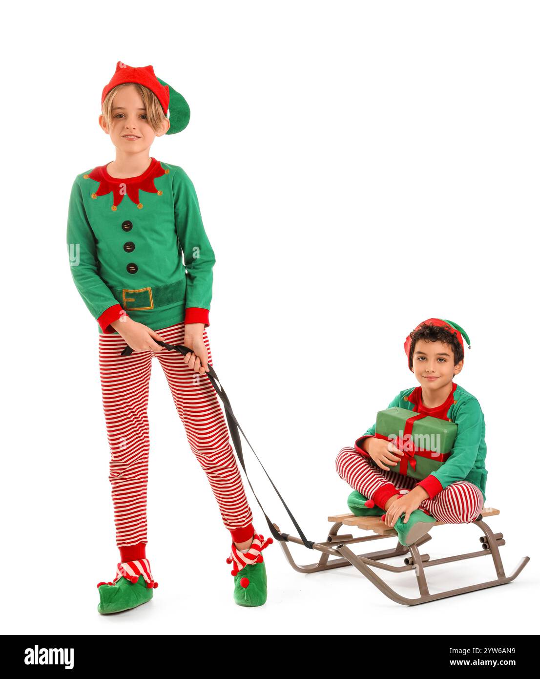 Cute little children in elves costumes with sledge and gift box ...