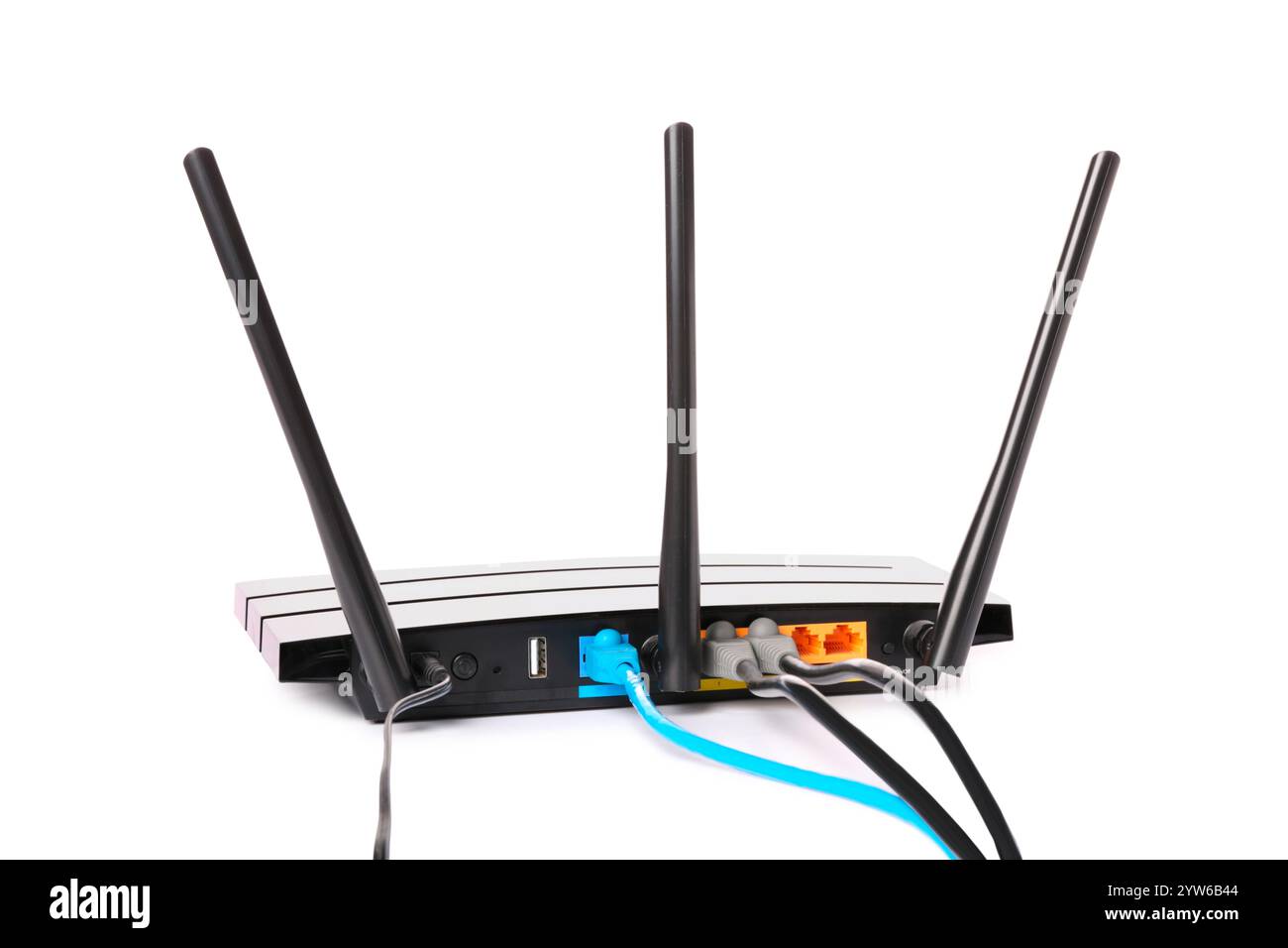 Modern wi-fi router with cables on white background Stock Photo - Alamy