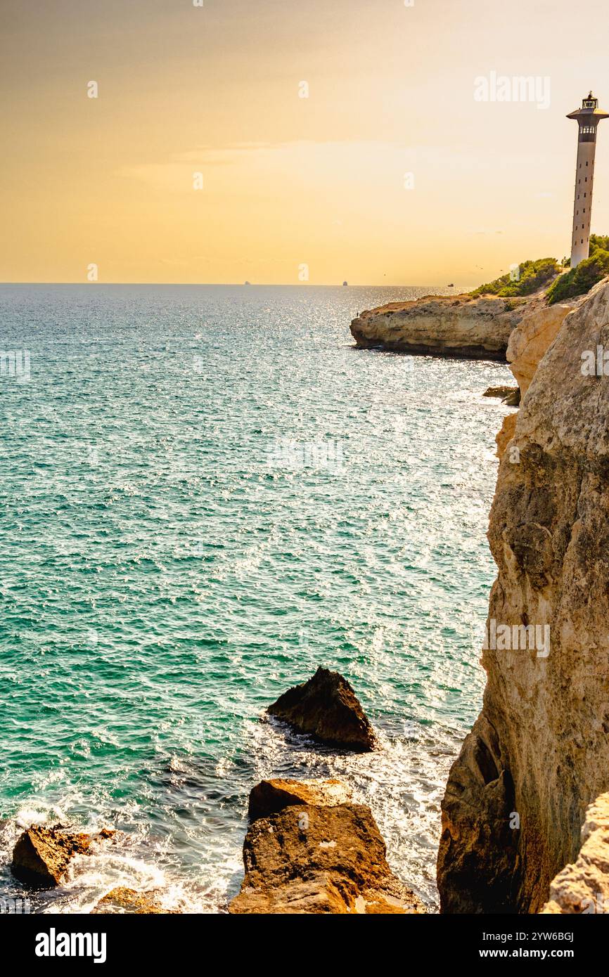 Coastal Lighthouse on Rocky Cliff with Turquoise Waters Below Stock ...