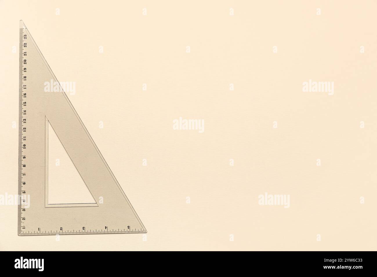 Wooden triangle ruler on color background Stock Photo - Alamy