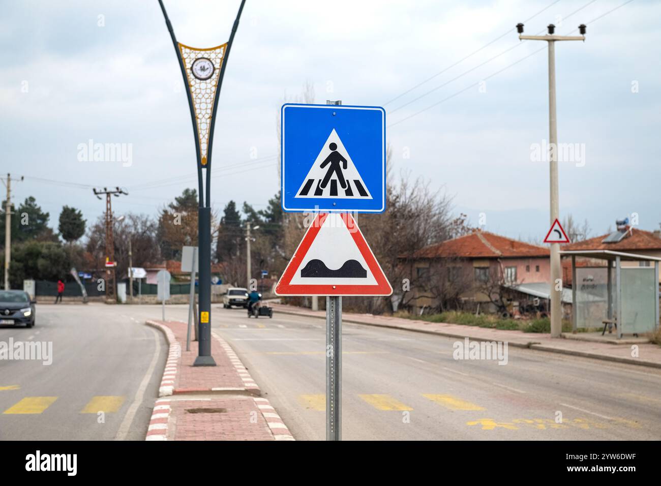 Pedestrian crossing road sign and uneven road sign Stock Photo - Alamy
