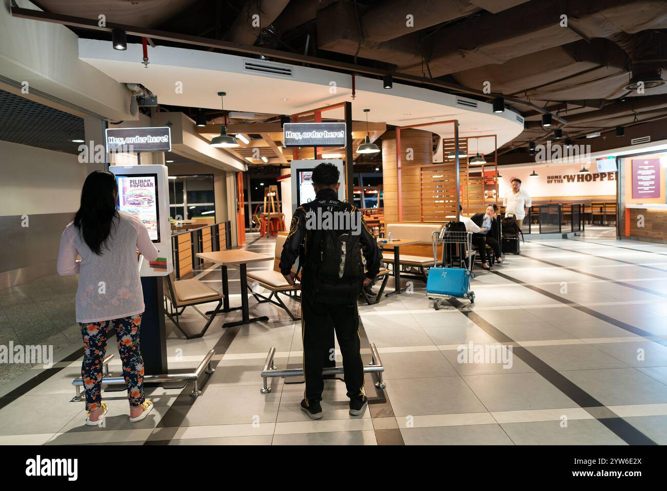 KUALA LUMPUR, MALAYSIA - NOVEMBER 22, 2023: people use self-service ...