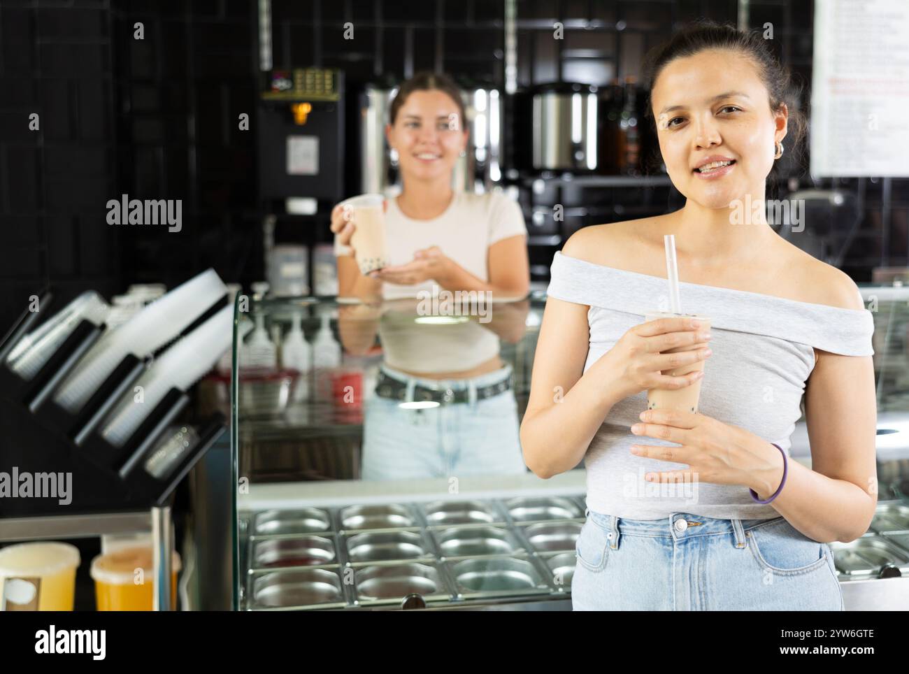 Young woman drinking bubble tea in cafe Stock Photo - Alamy