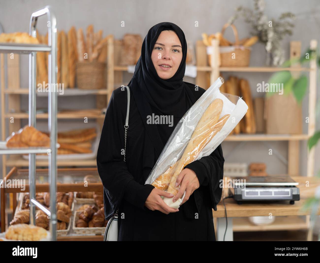 Muslim customer with fresh baguette in bakery Stock Photo - Alamy