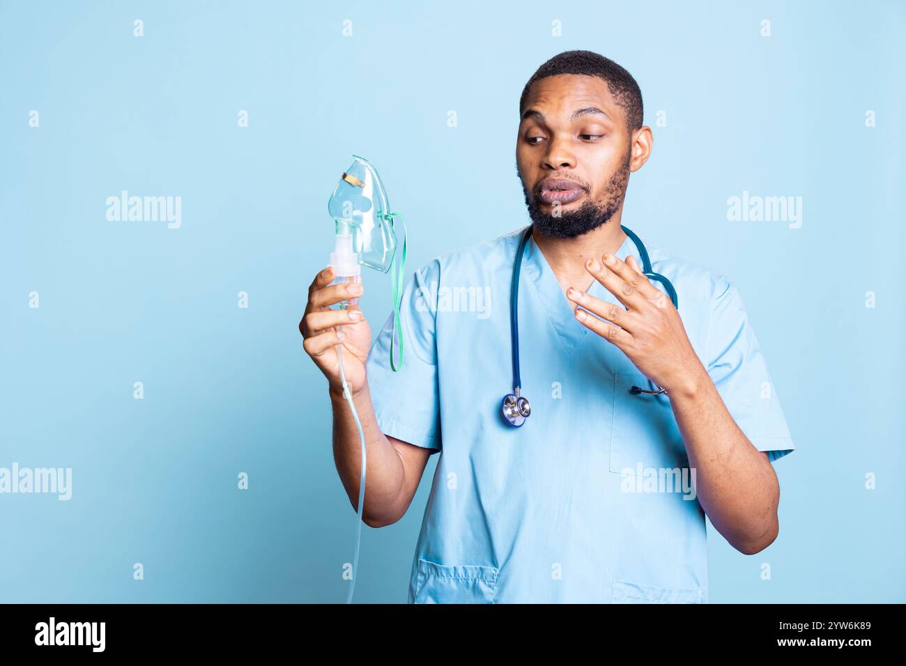 Male nurse doing medical instruction video on how to use handheld ...