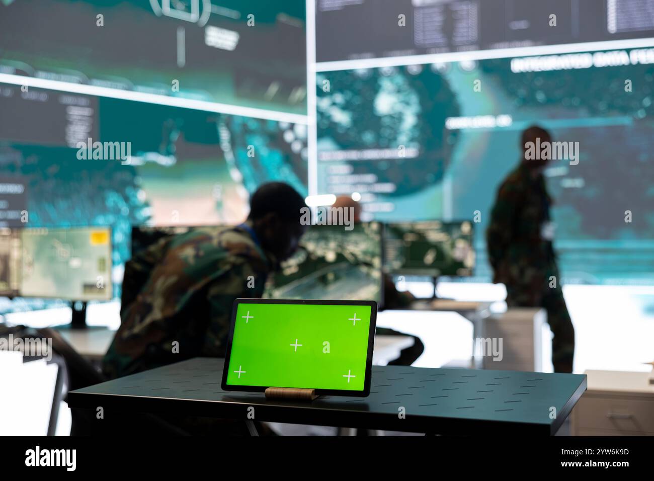 Military headquarters monitoring room with a mockup green screen on ...