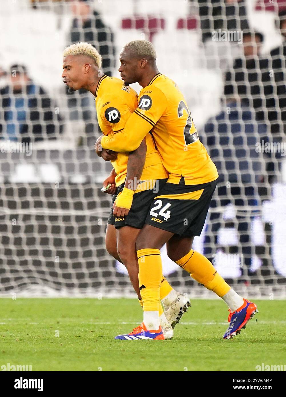 Wolverhampton Wanderers' Mario Lemina (left) appears to be held back by ...