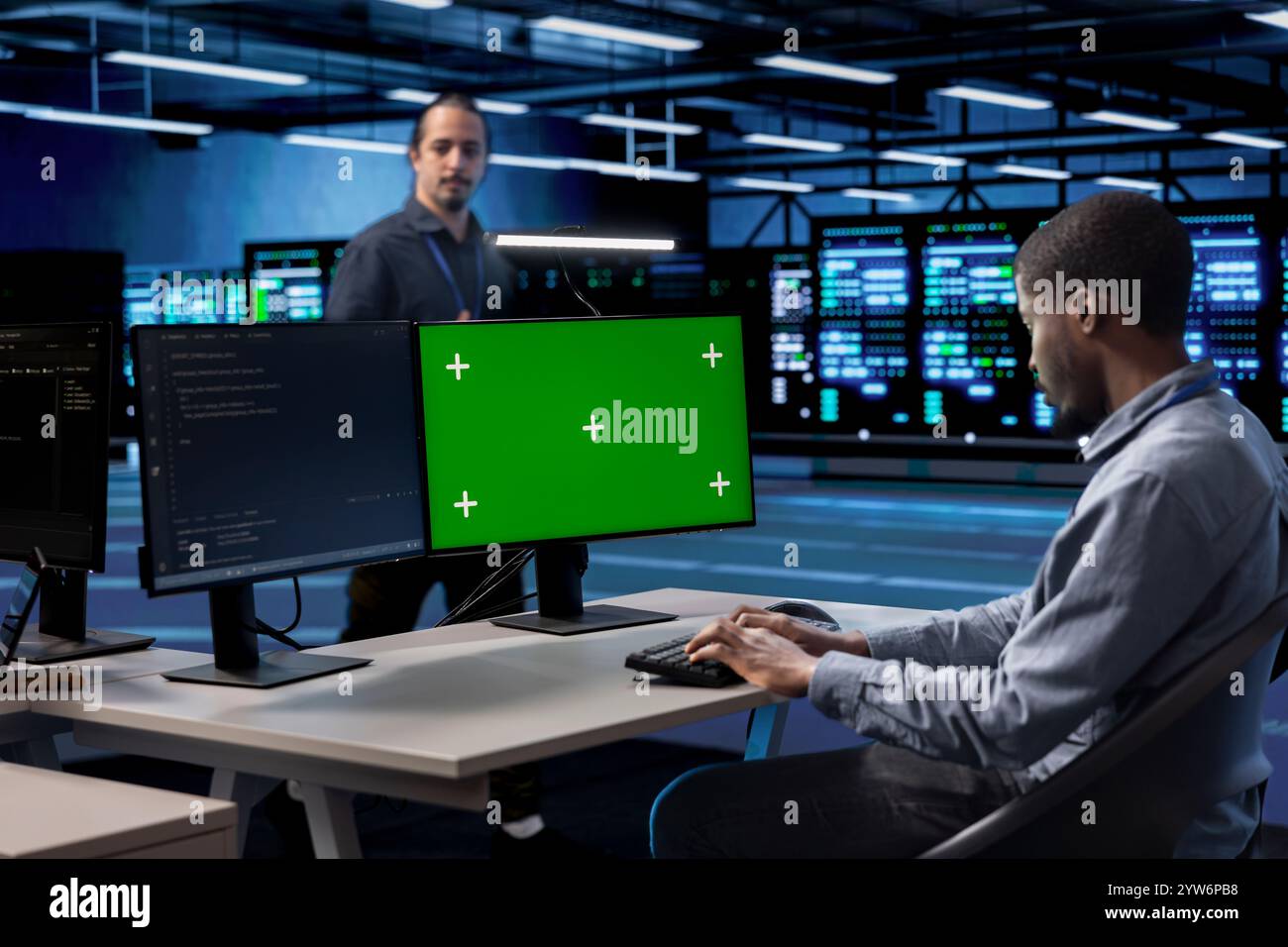 Developer in server room checking recovery plan and monitoring energy consumption using isolated ...