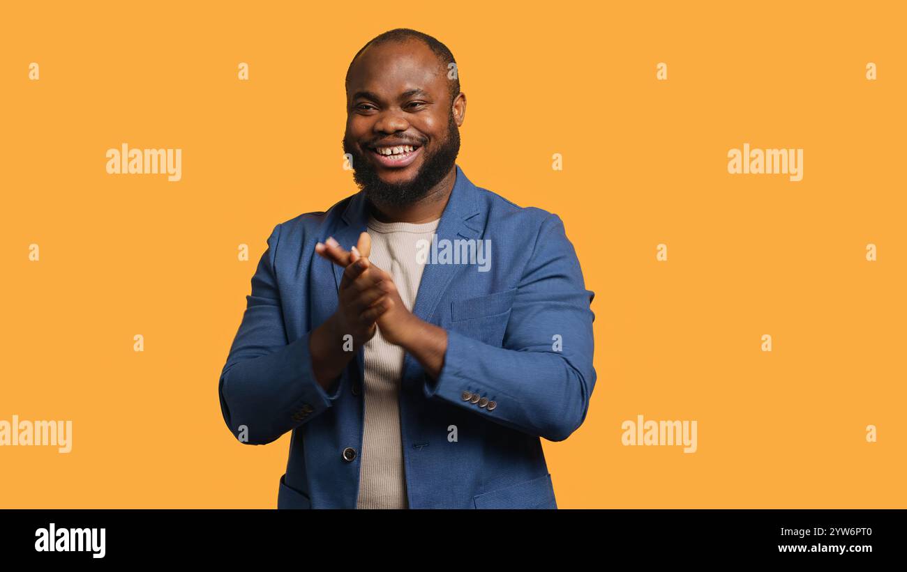 Approving smiling african american man happily clapping hands ...