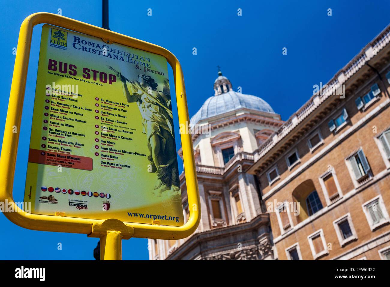 Visitors gather at the bus stop for the Christian Rome tour near the ...