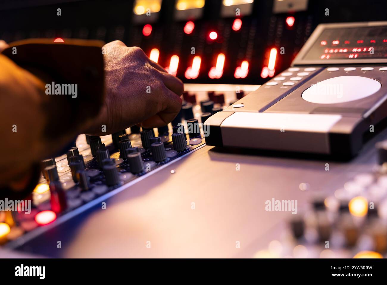 African american sound designer operates mixing console in control room ...
