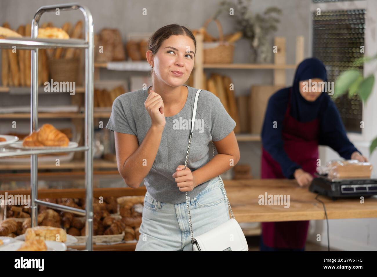 Girl choosing fresh pastries from display at Muslim bakery Stock Photo ...