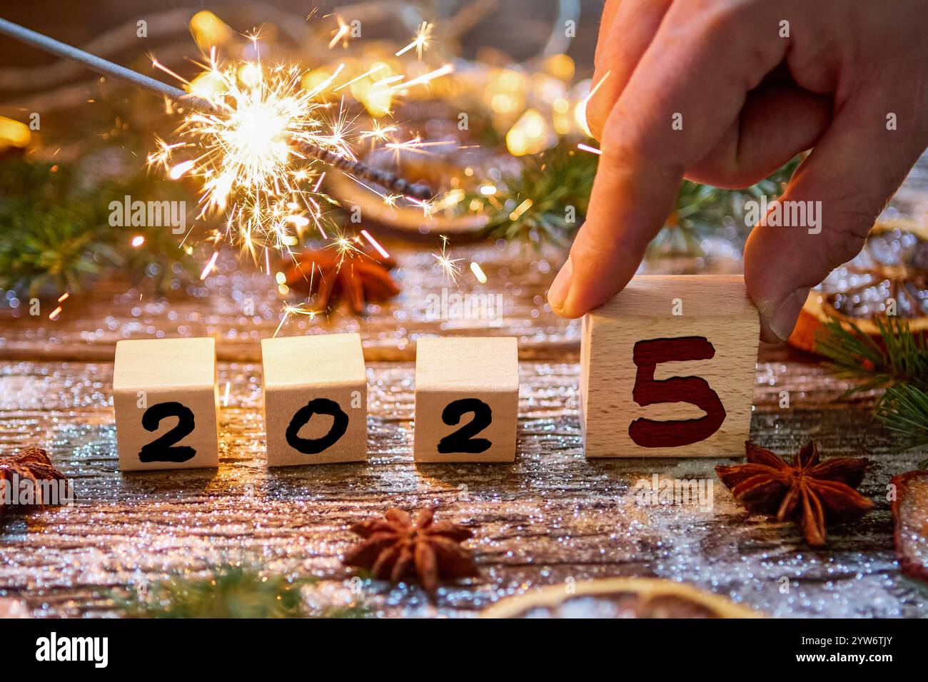 9 December 2024: Wooden cube with the year 2025, accompanied by sparks ...