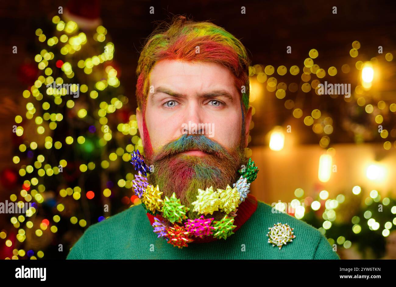 Christmas beard style. Serious bearded man with Christmas baubles in ...