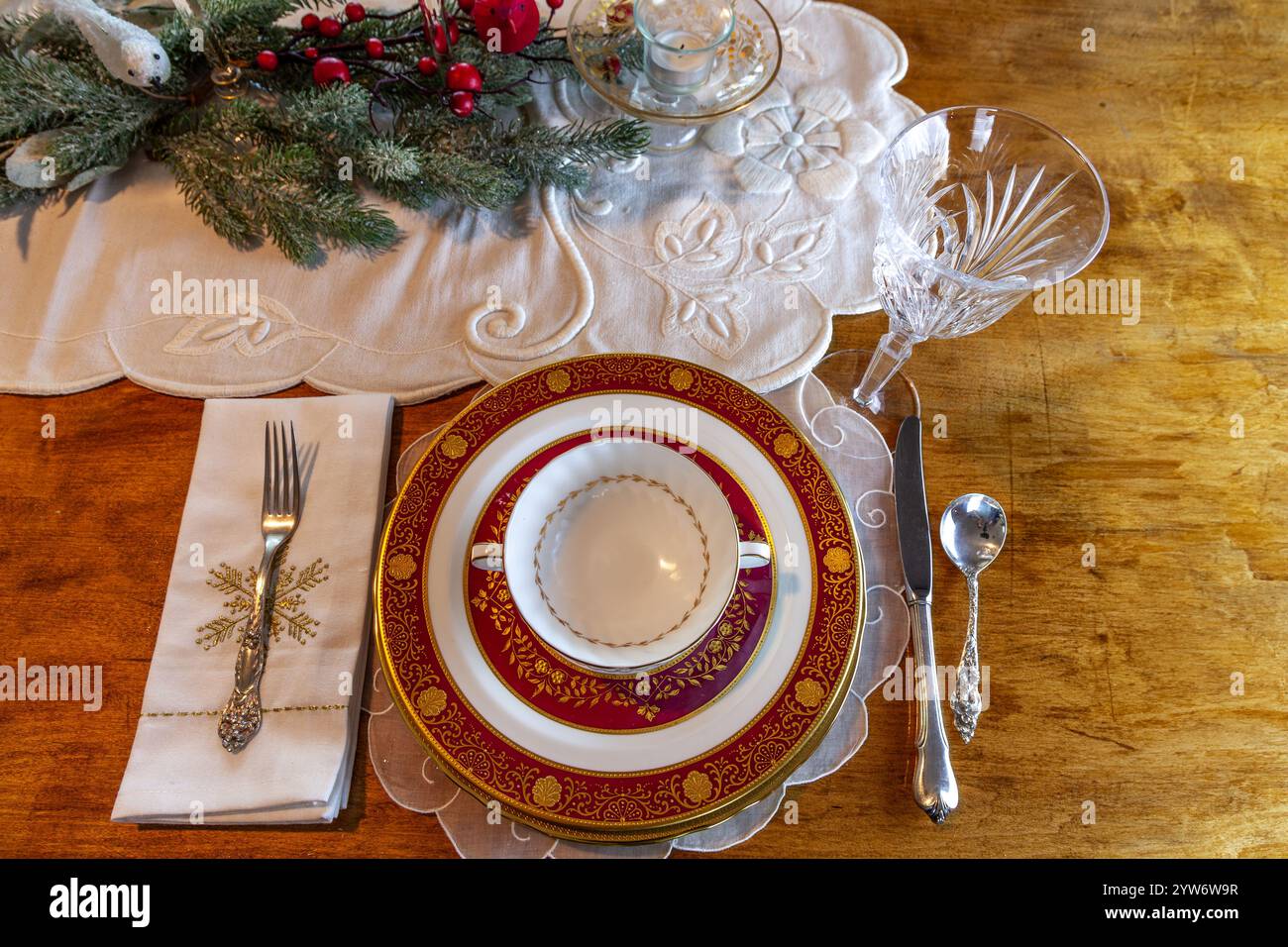 Holiday fine bone China place settings with gold gilded plates on a ...