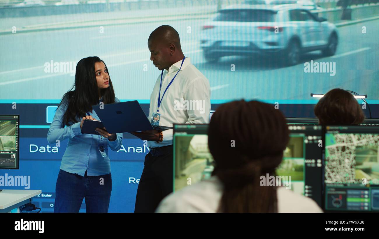 Team leaders reviewing traffic data collected from video surveillance ...