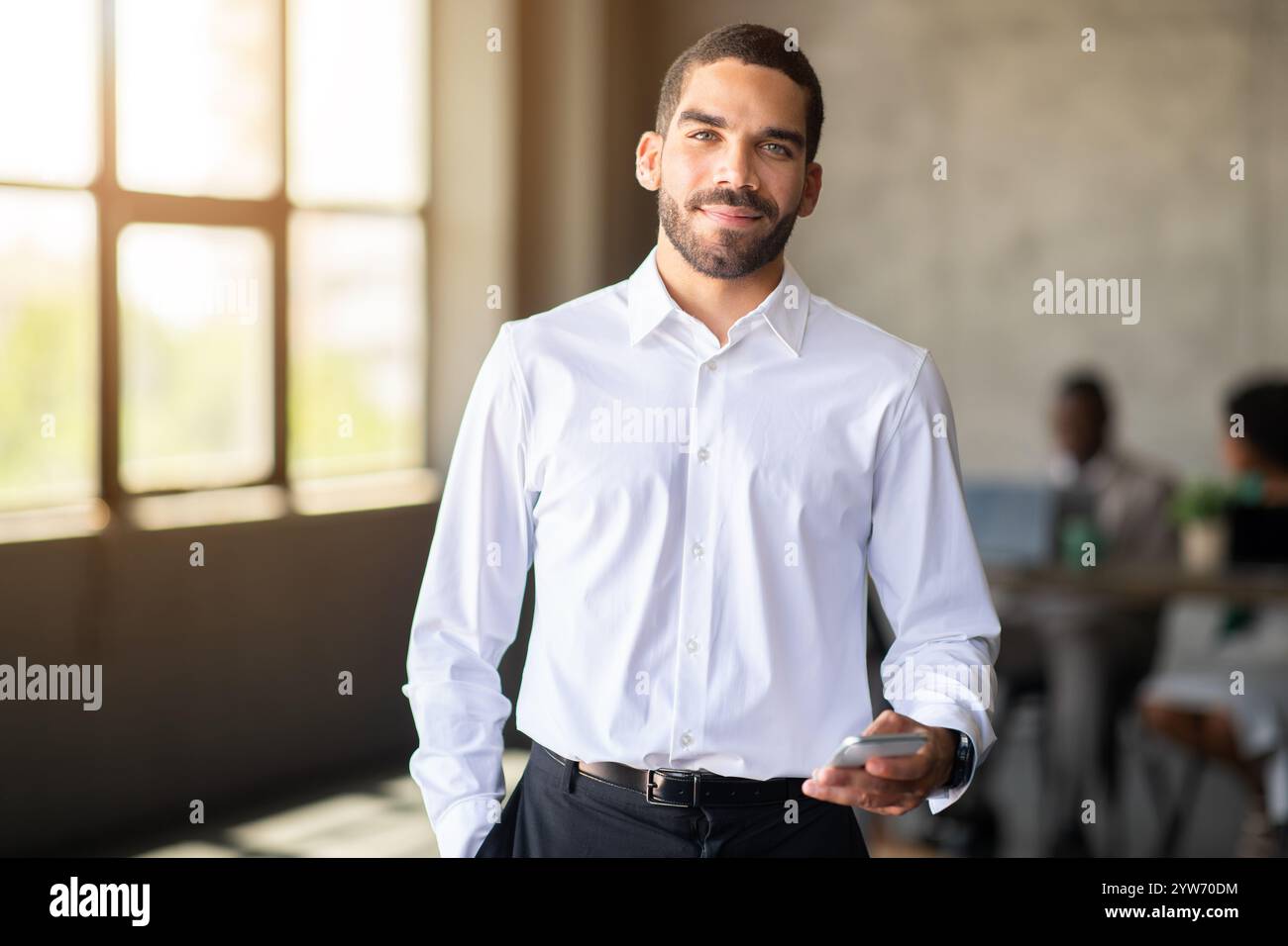 Professional man engaging with colleagues in an office setting Stock ...