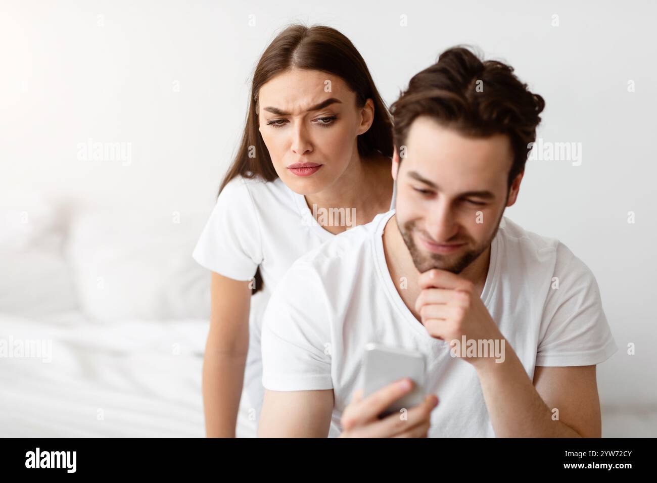 Suspicious Wife Reading Husband's Messages On Smartphone Behind Back ...