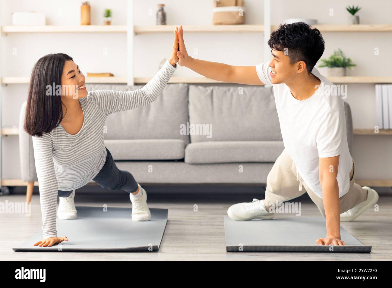 Joyful asian man and woman cheering up while planking Stock Photo - Alamy