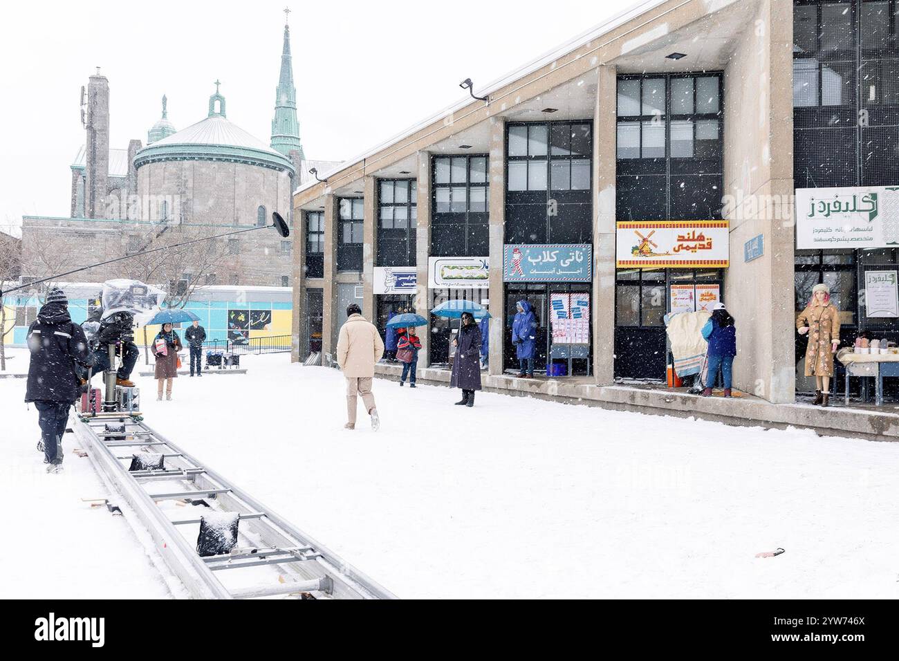 UNIVERSAL LANGUAGE, (aka UNE LANGUE UNIVERSELLE), center in beige coat and pants: director ...