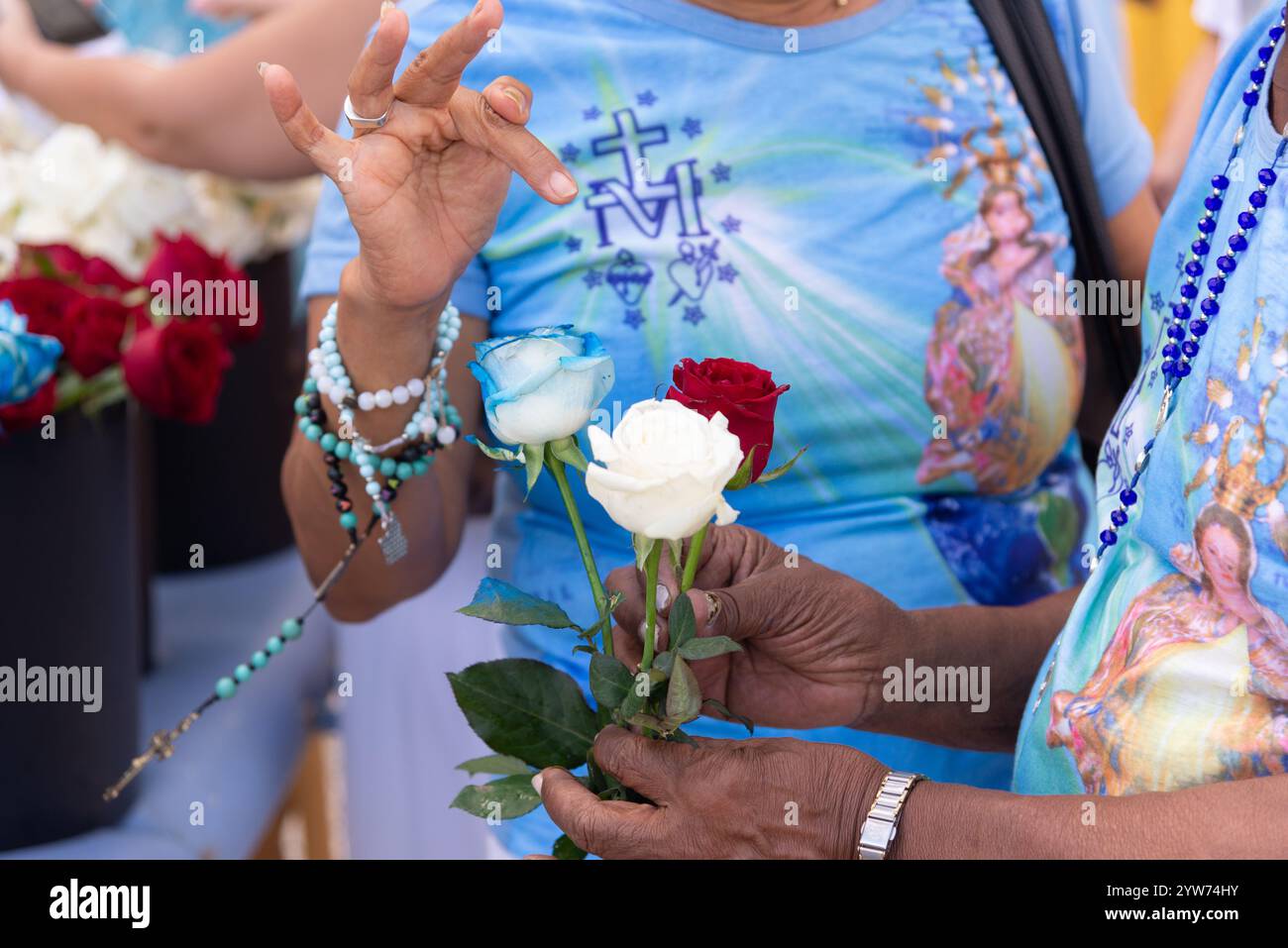 Salvador, Bahia, Brazil - December 08, 2024: Catholics are seen holding ...