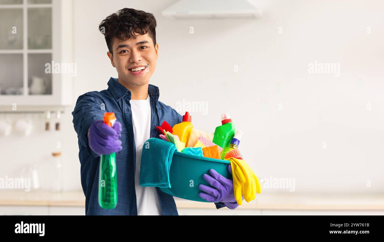 Handsome asian guy showing his cleaning tools Stock Photo - Alamy
