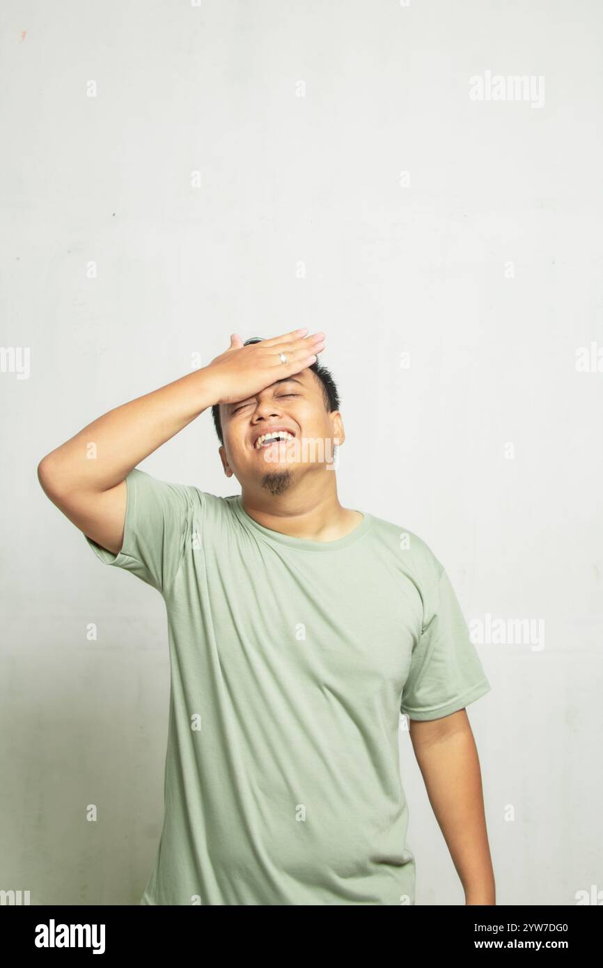 Asian man with glasses holding forehead feeling dizzy isolated on white ...