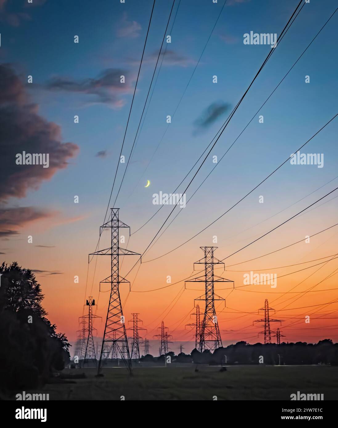 High Voltage Power Lines at Sunset with Crescent Moon in the Sky Stock ...