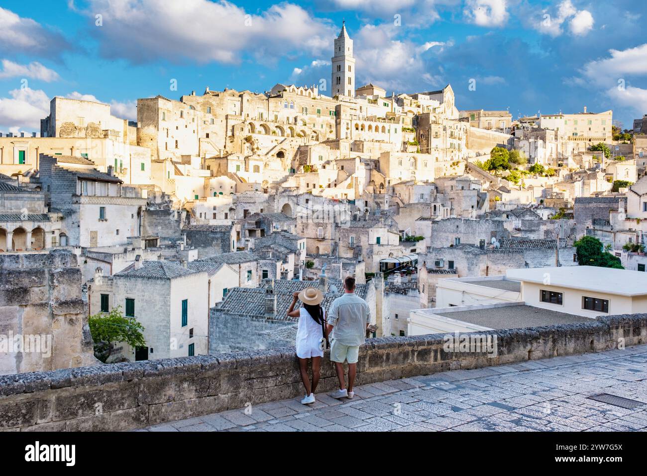 A couple stands hand in hand, marveling at the stunning landscape of ...