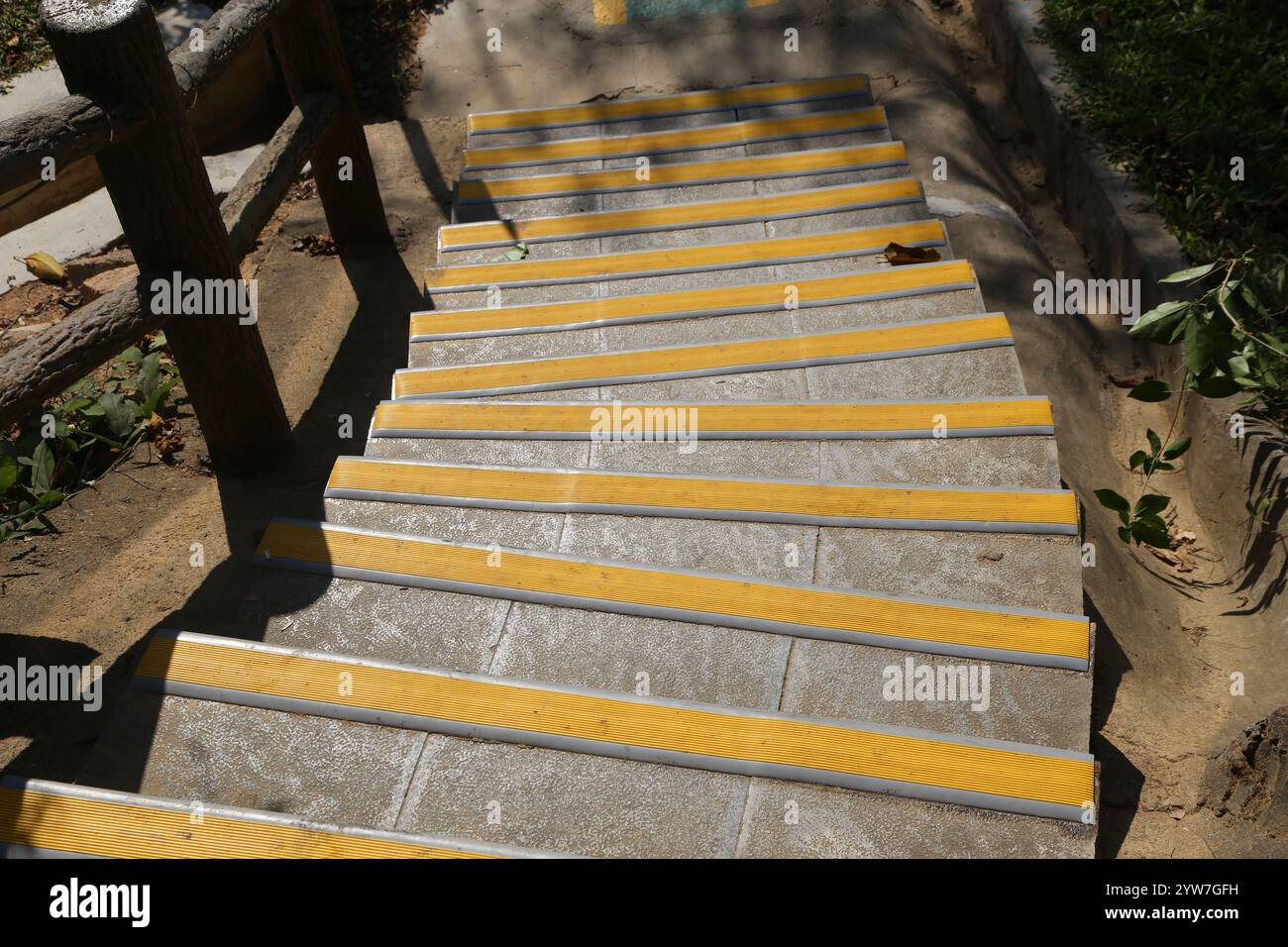 A yellow and white staircase with a yellow stripe. The yellow stripe is ...