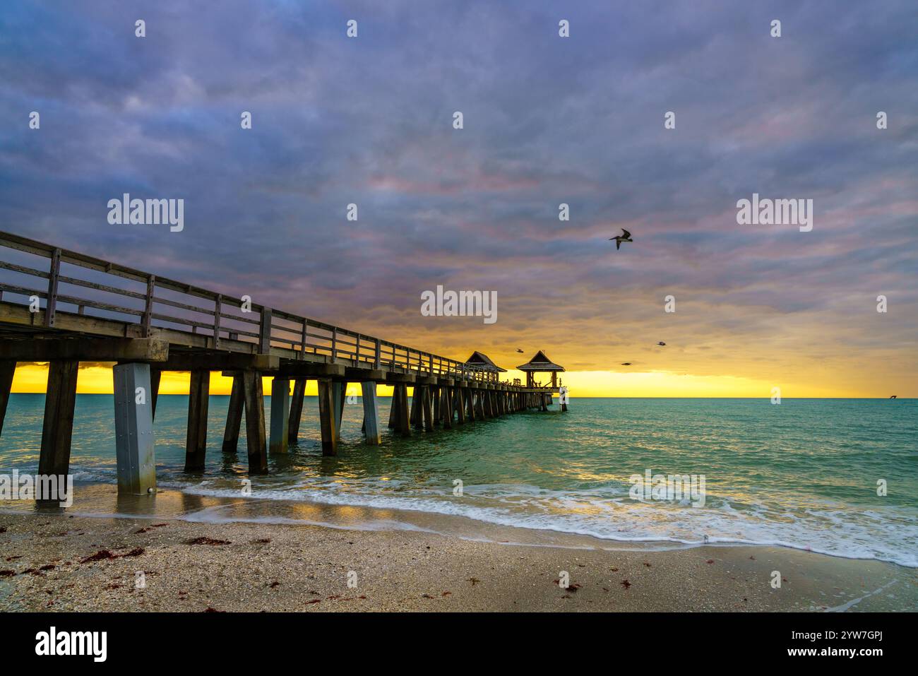 Pier and the beach in Naples, Florida, at sunset Stock Photo - Alamy