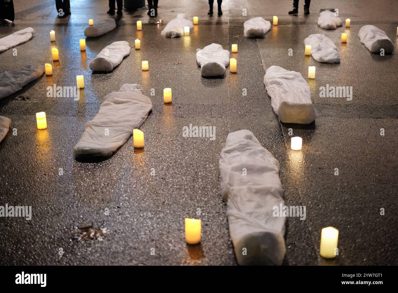 Ljubljana, Slovenia. 09th Dec, 2024. Candles and dummies of shrouded ...