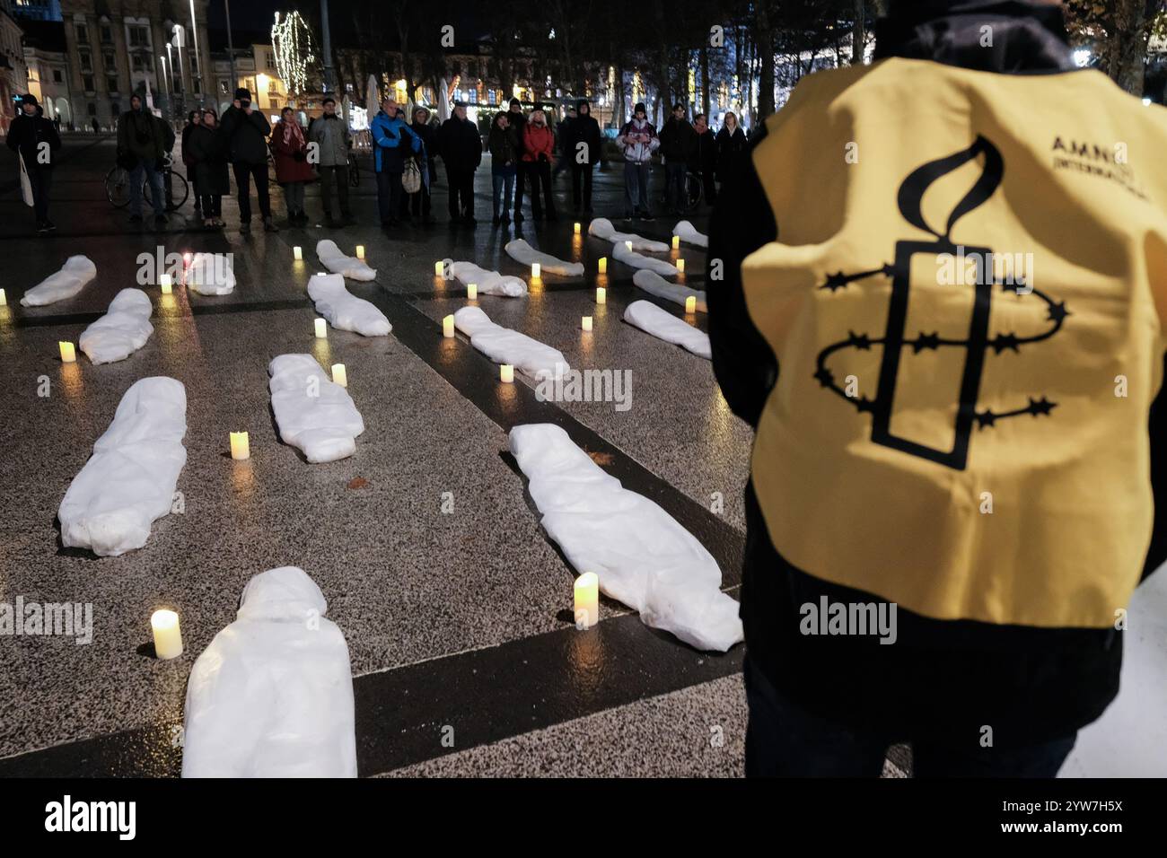 Ljubljana, Slovenia. 09th Dec, 2024. Candles and dummies of shrouded ...