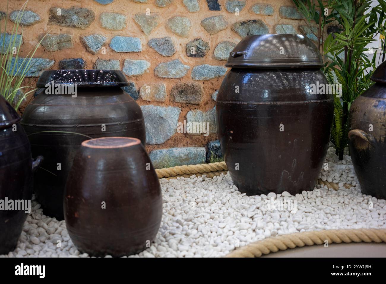 Korean traditional various shapes of ceramic jars, pots in front of ...