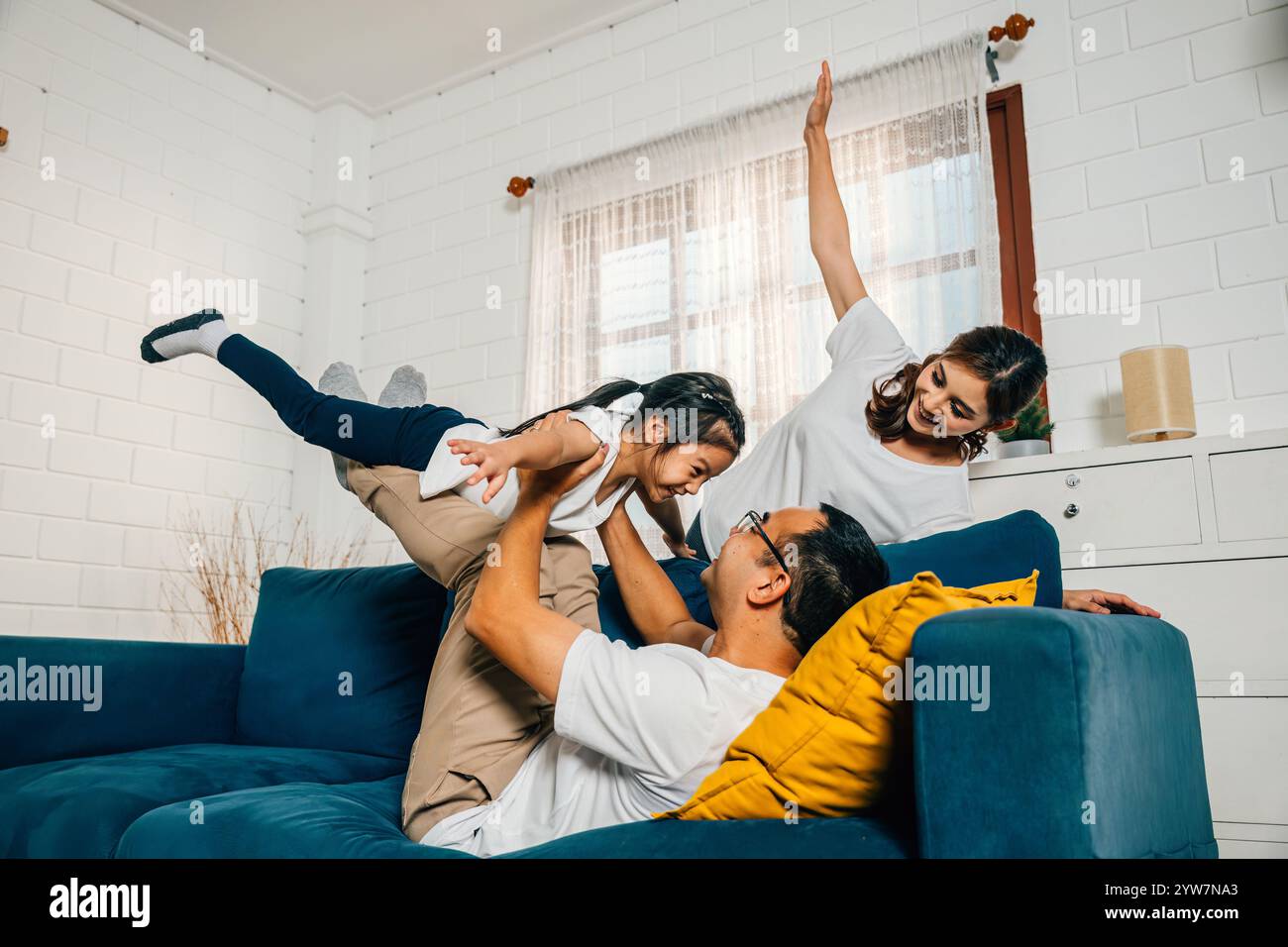 A family shares moments of joy and happiness during an airplane game in ...