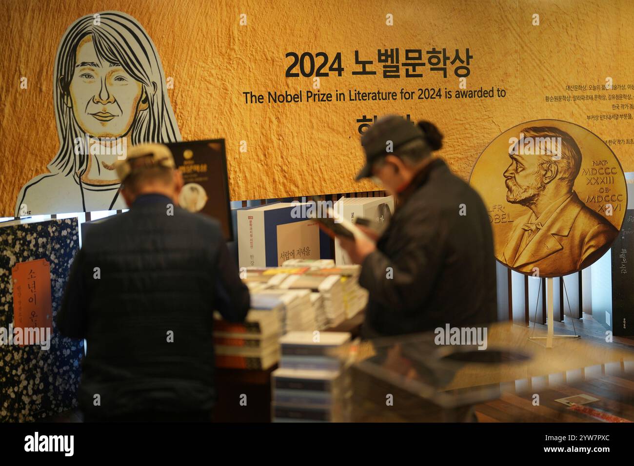 Visitors read books written by South Korean author Han Kang, this year's winner of the Nobel ...