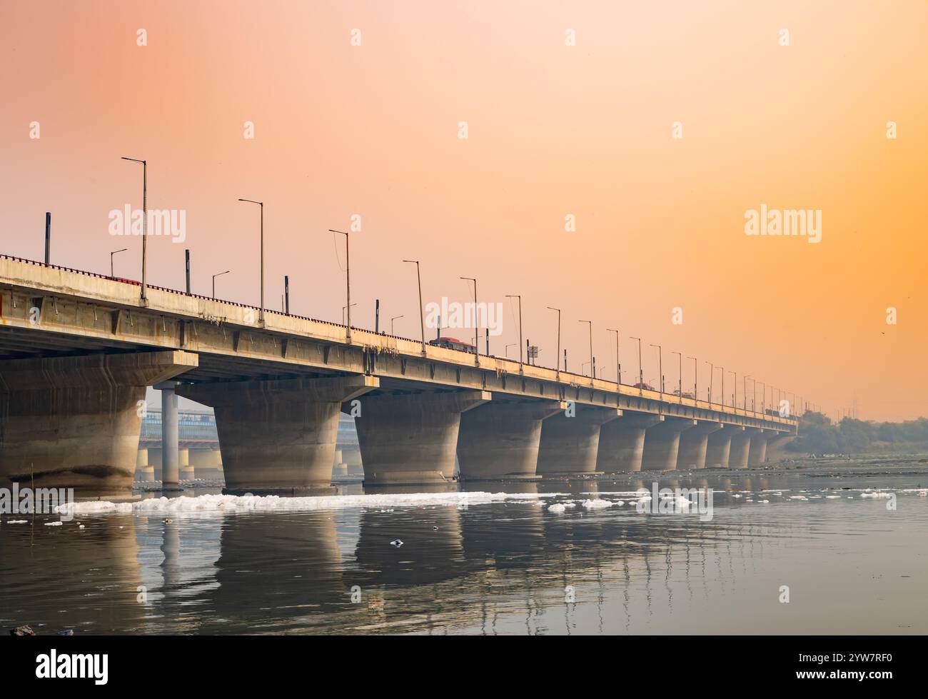 road bridge with polluted river with industrial and domestic effluents ...