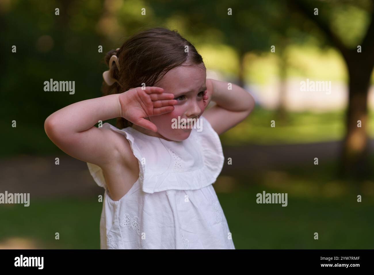 Little cute girl without front teeth on playground in summer in park ...