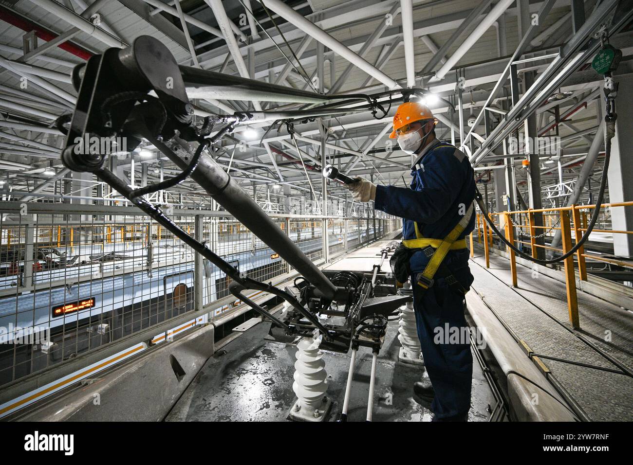 NANJING, CHINA - DECEMBER 10, 2024 - A ground service mechanic inspects ...