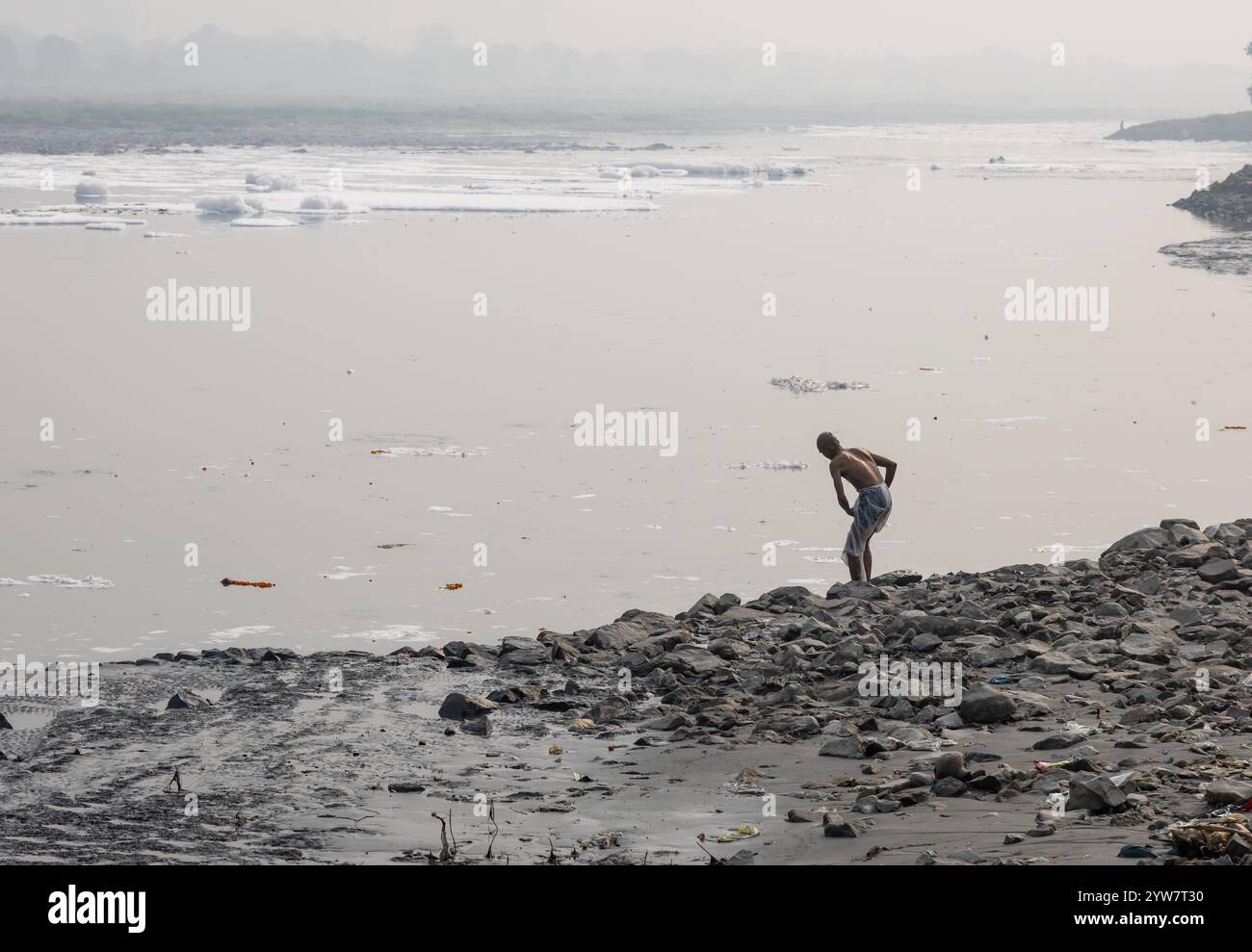 Isolated man bathing in Polluted River with Toxic Foam at misty Morning ...