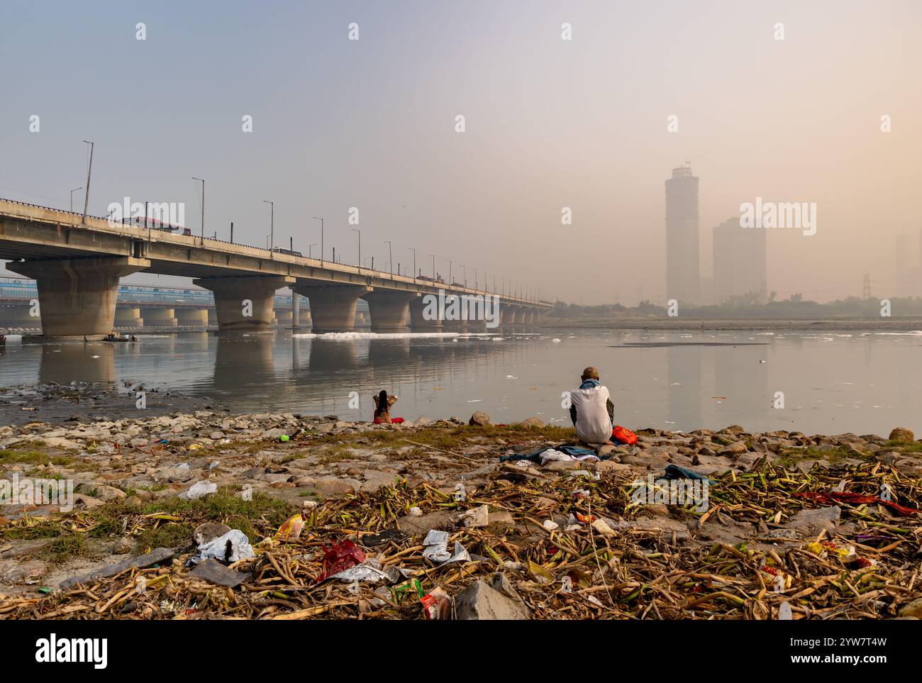 devotee performing holy rituals at Polluted River shore with Toxic Foam ...