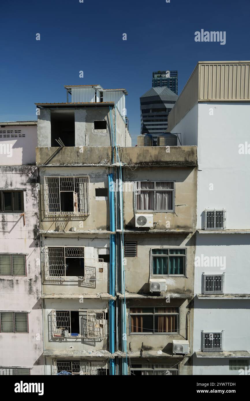 Bangkok old housing or apartment building, with many caged windows and ...