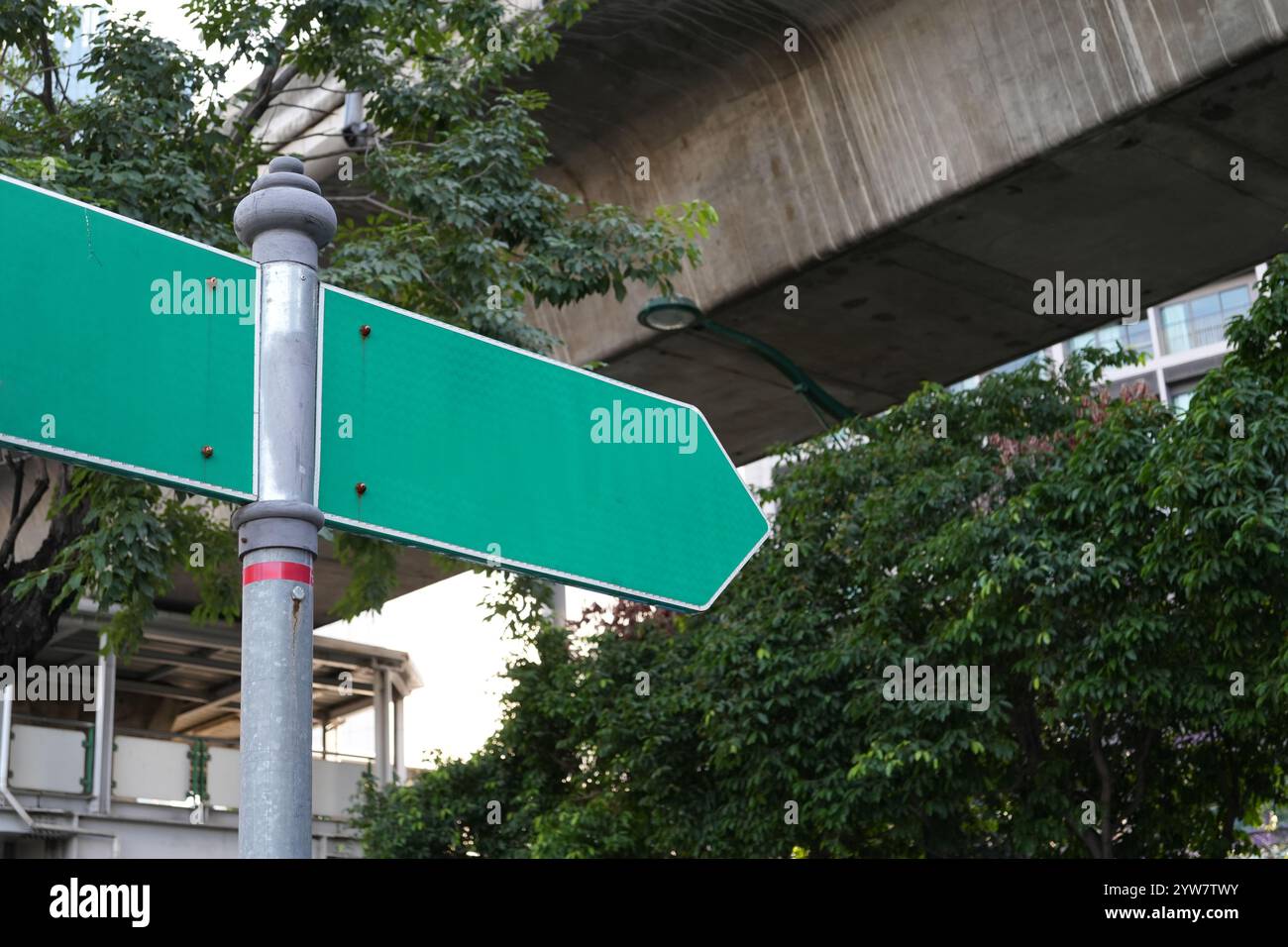 Blank right pointer directional arrows signpost on the side of the road ...