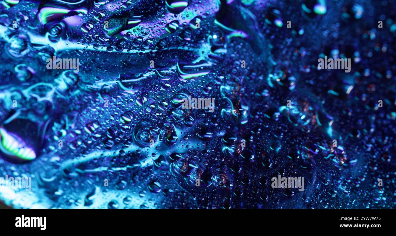 Shiny drops. Moisture metal. Blue illuminated area covered with watered ...