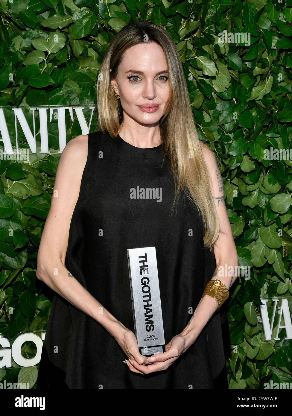 Actor Angelina Jolie poses with the performer tribute award for her ...