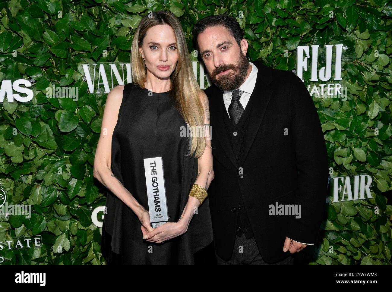 Actor Angelina Jolie, left, poses with the performer tribute award for ...