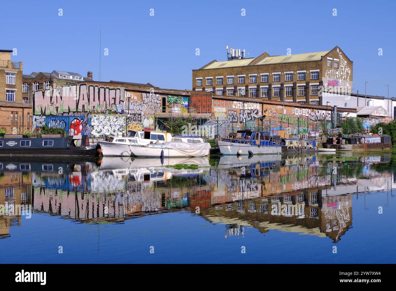 Colourful graffiti (street art), canal boats, barges, industrial ...