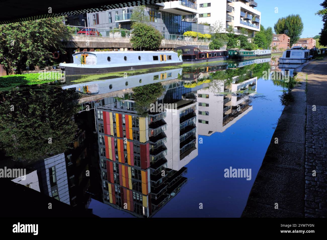 Mirror reflections of colourful Matchmakers Wharf, canal boats, barges ...