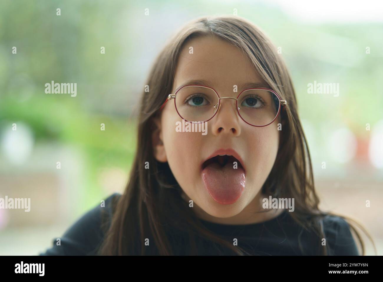 Little cute smiling girl with all her teeth in front of a big ...