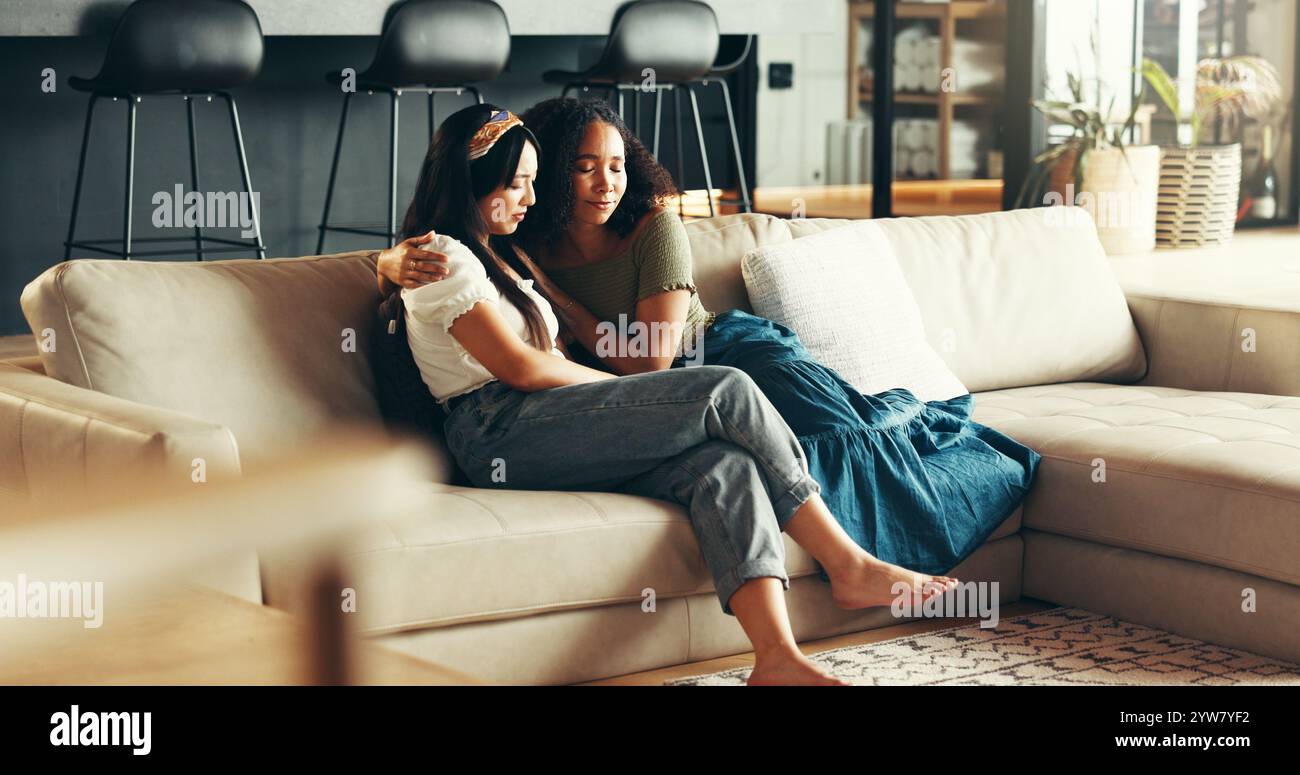 House, comfort and women on sofa, hug and sad with emotion, support and relax. People, apartment ...